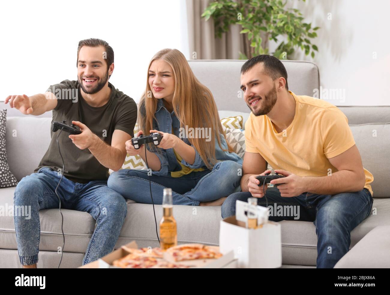 Young people playing video games at home Stock Photo - Alamy