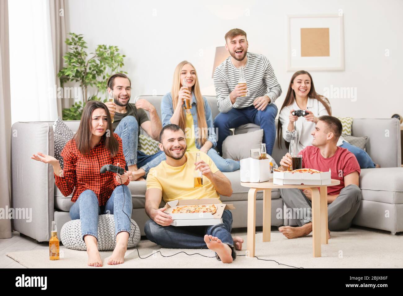 Young people playing video games at home Stock Photo - Alamy