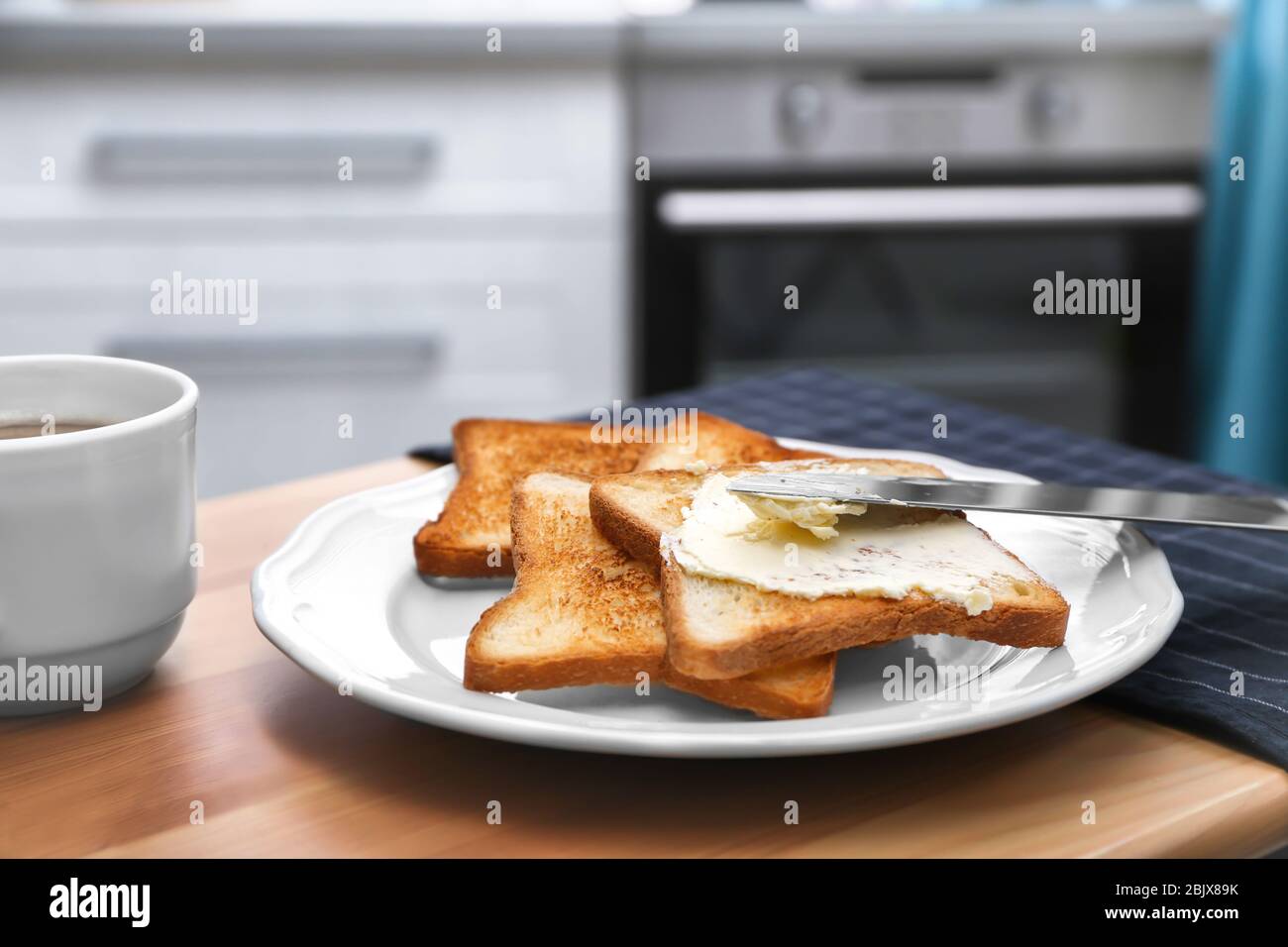 Toasted bread served with butter on plate Stock Photo - Alamy