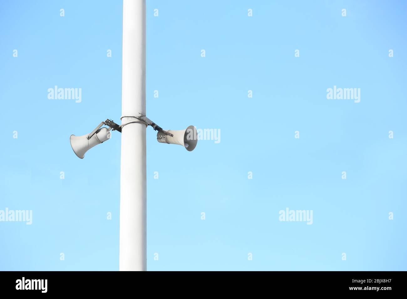 Megaphones on pole outdoors Stock Photo - Alamy