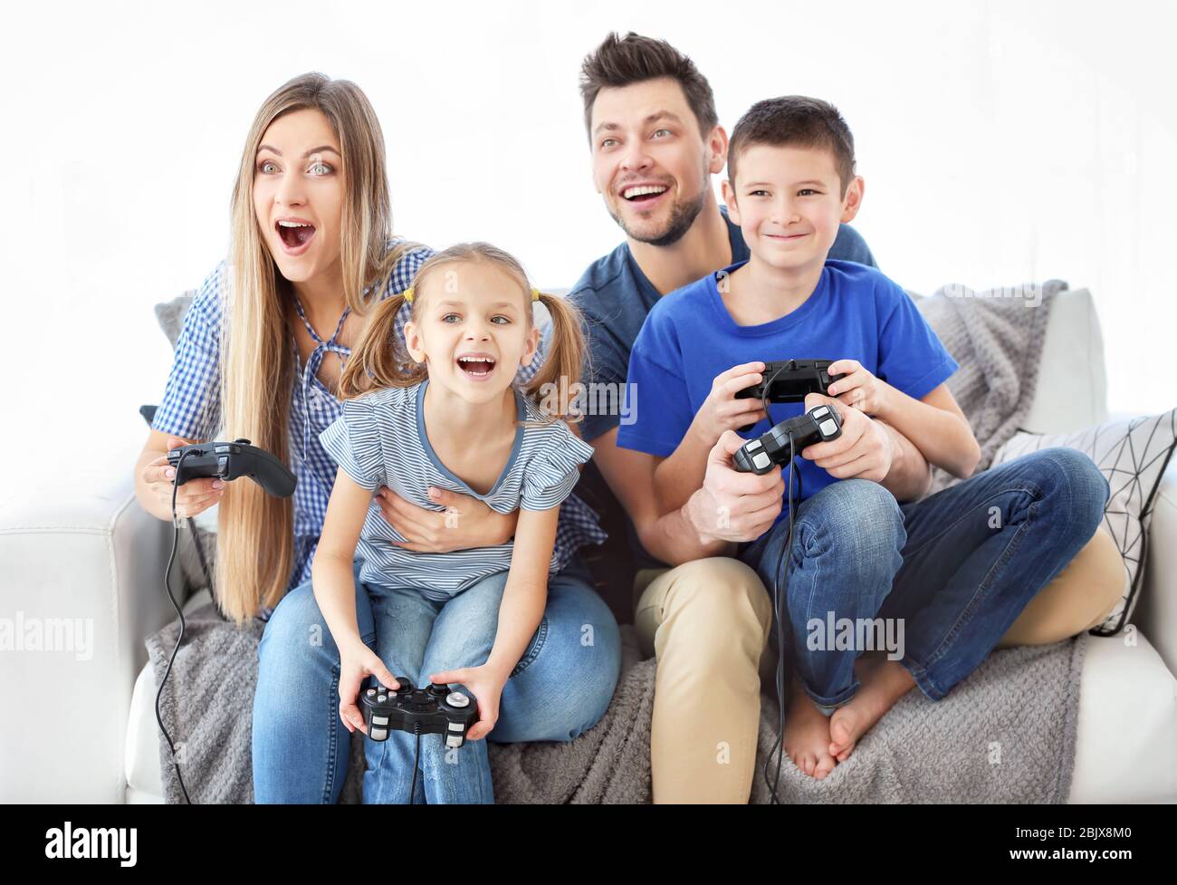 Happy family playing video games at home Stock Photo - Alamy