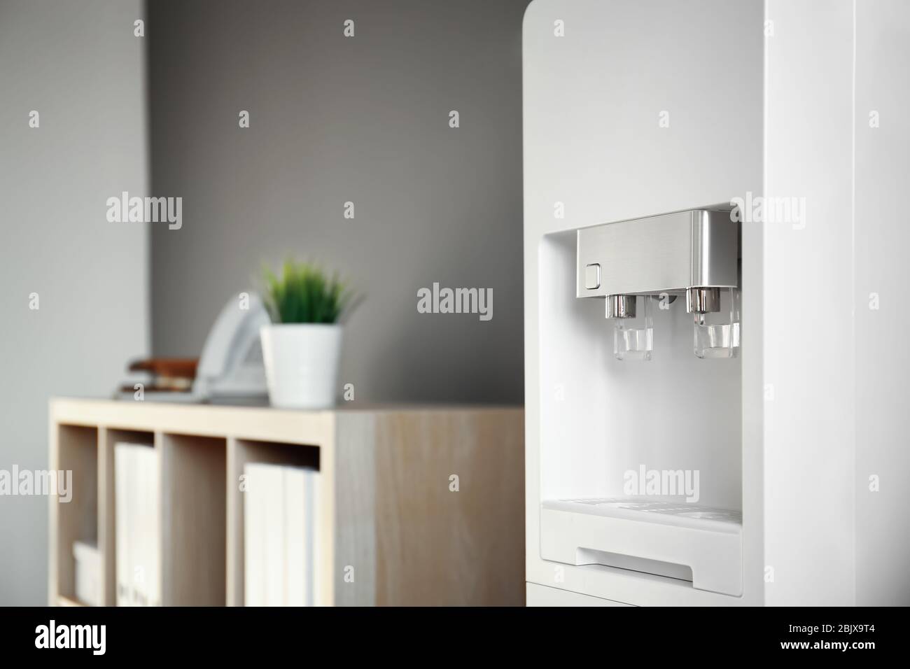 Modern water cooler in office Stock Photo - Alamy