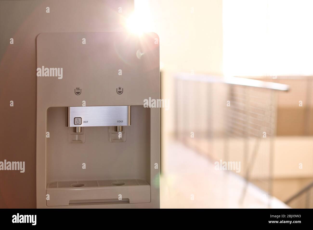 Modern water cooler, indoors Stock Photo - Alamy