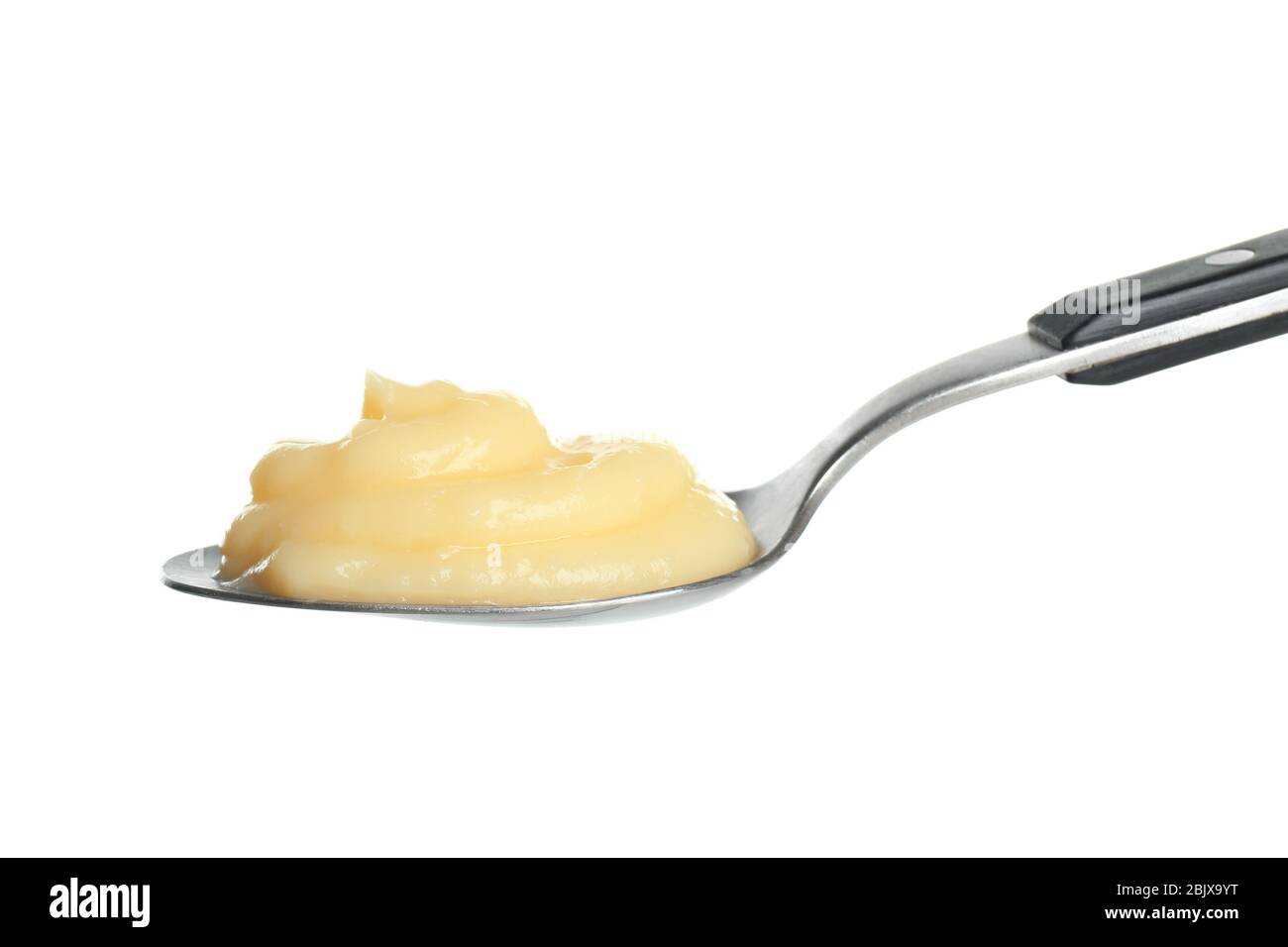 Tasty vanilla pudding in spoon on white background Stock Photo - Alamy