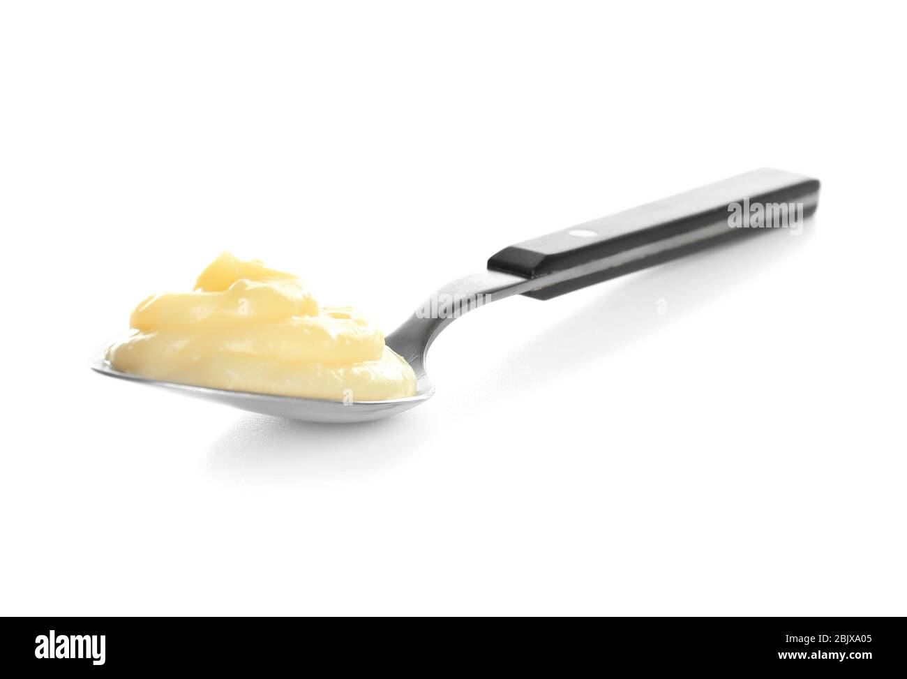 Tasty vanilla pudding in spoon on white background Stock Photo - Alamy