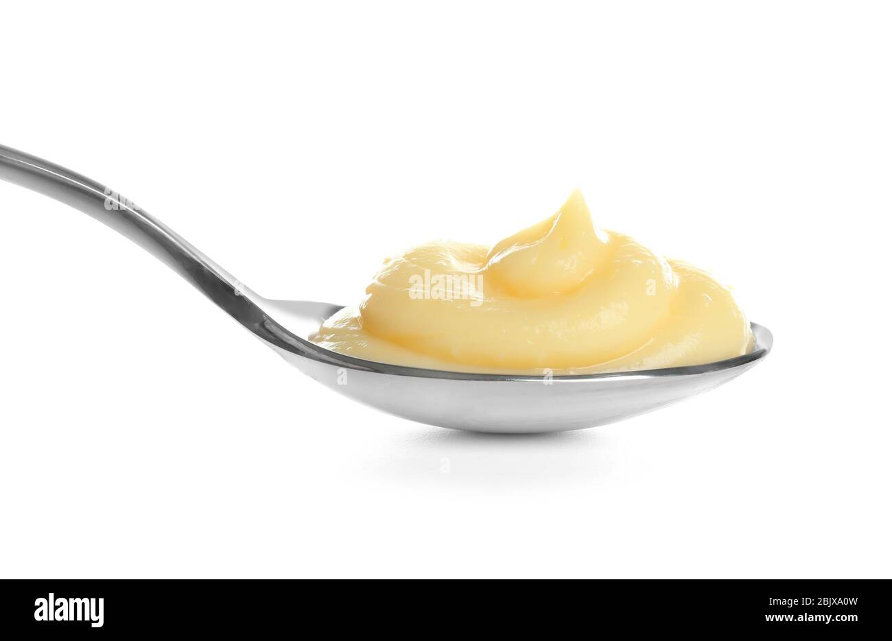 Tasty vanilla pudding in spoon on white background Stock Photo - Alamy