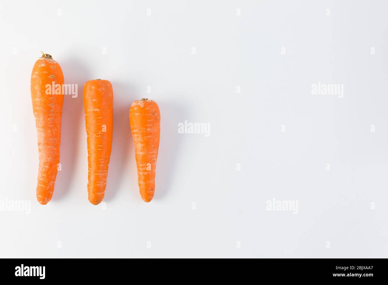 Group of three carrots isolated on white background Stock Photo - Alamy