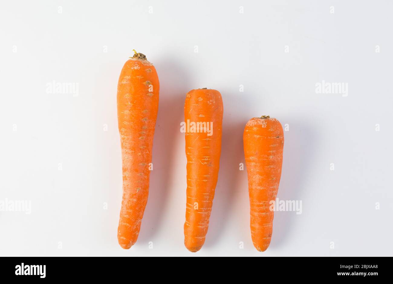 Group of three carrots isolated on white background Stock Photo - Alamy