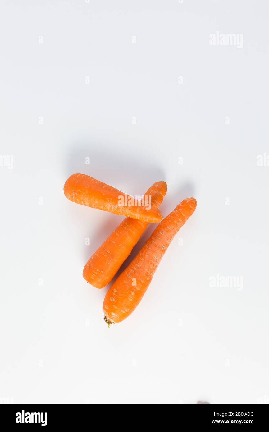 Group of three carrots isolated on white background Stock Photo - Alamy