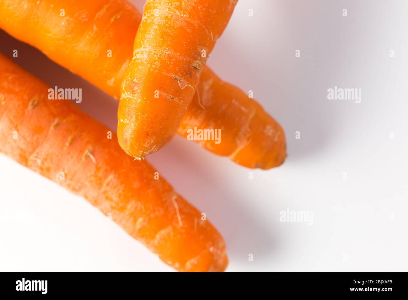 Group of three carrots isolated on white background Stock Photo - Alamy