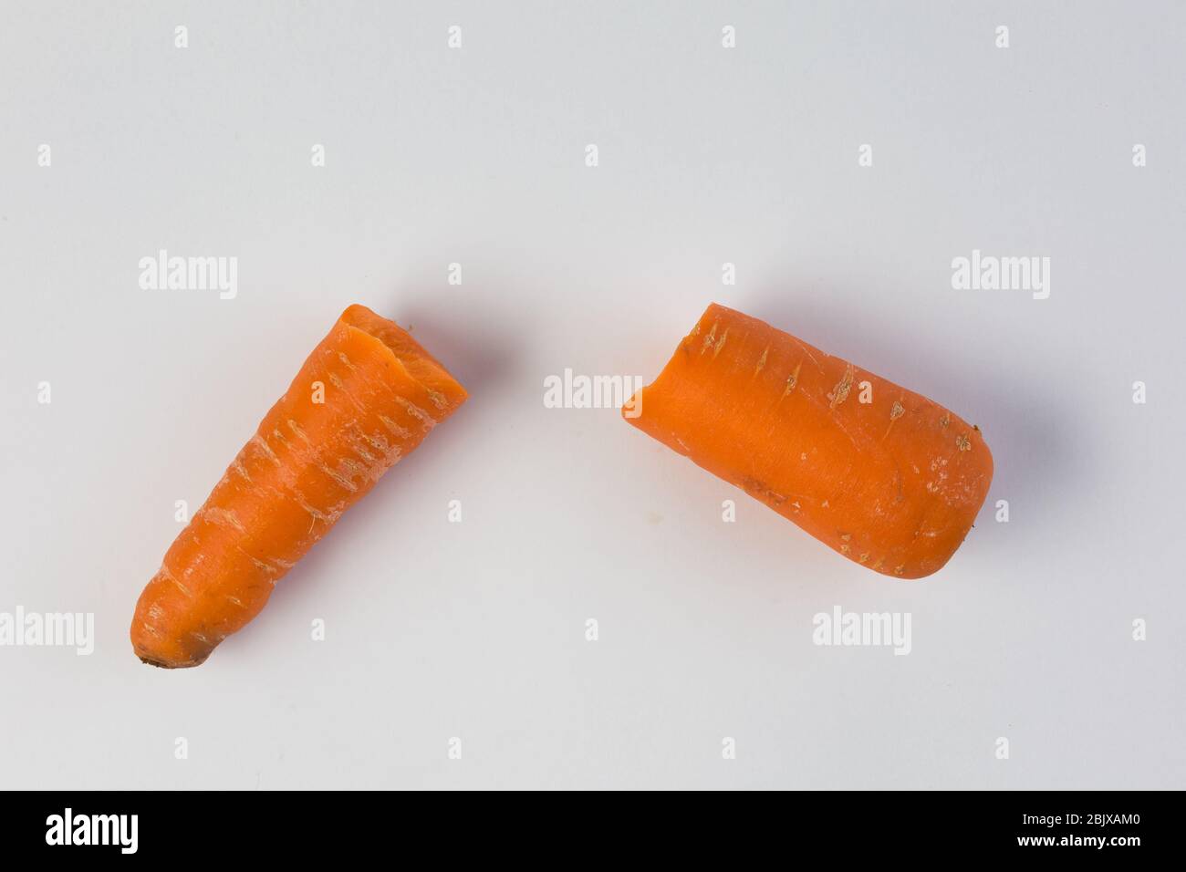 Broken One carrots isolated on white background Stock Photo - Alamy