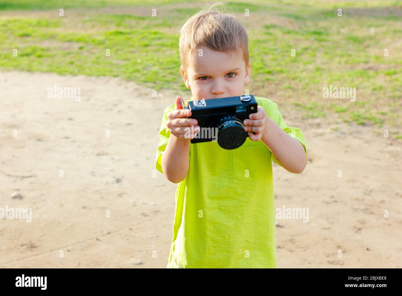 Little boy using vintage camera. Cute caucasian child taking photo with ...