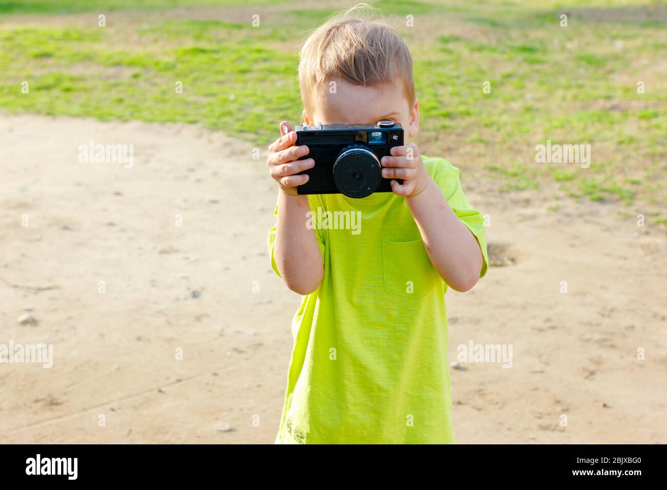 Little boy using vintage camera. Cute caucasian child taking photo with ...