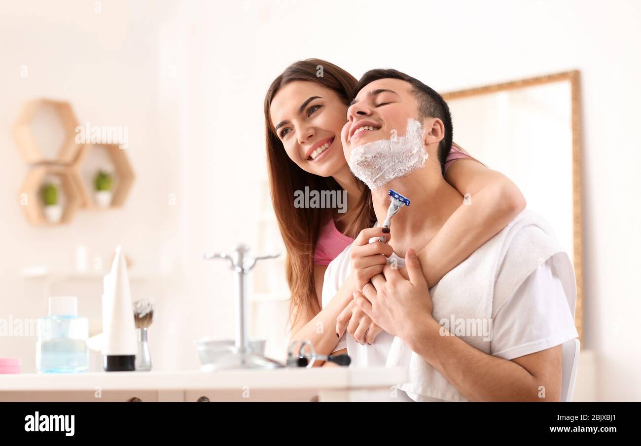 Young woman helping her boyfriend shaving in bathroom Stock Photo - Alamy