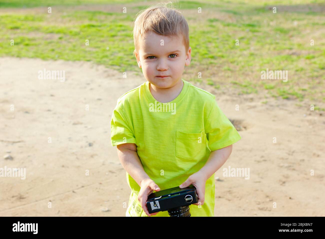 Little boy using vintage camera. Cute caucasian child taking photo with ...