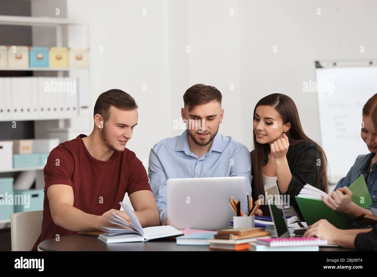 Students doing homework together in library Stock Photo - Alamy