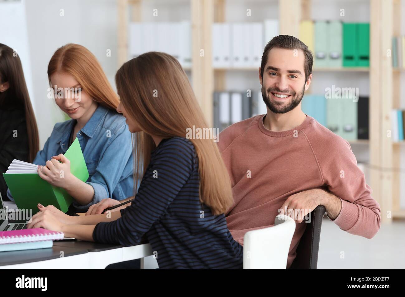 Students doing homework together in library Stock Photo - Alamy