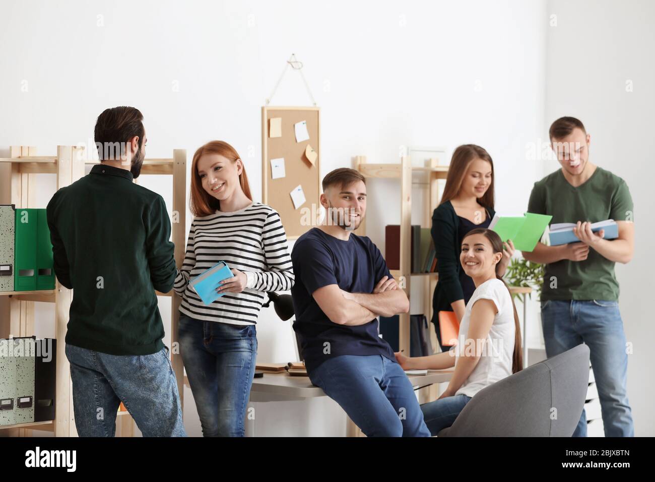Students doing homework together in classroom Stock Photo - Alamy