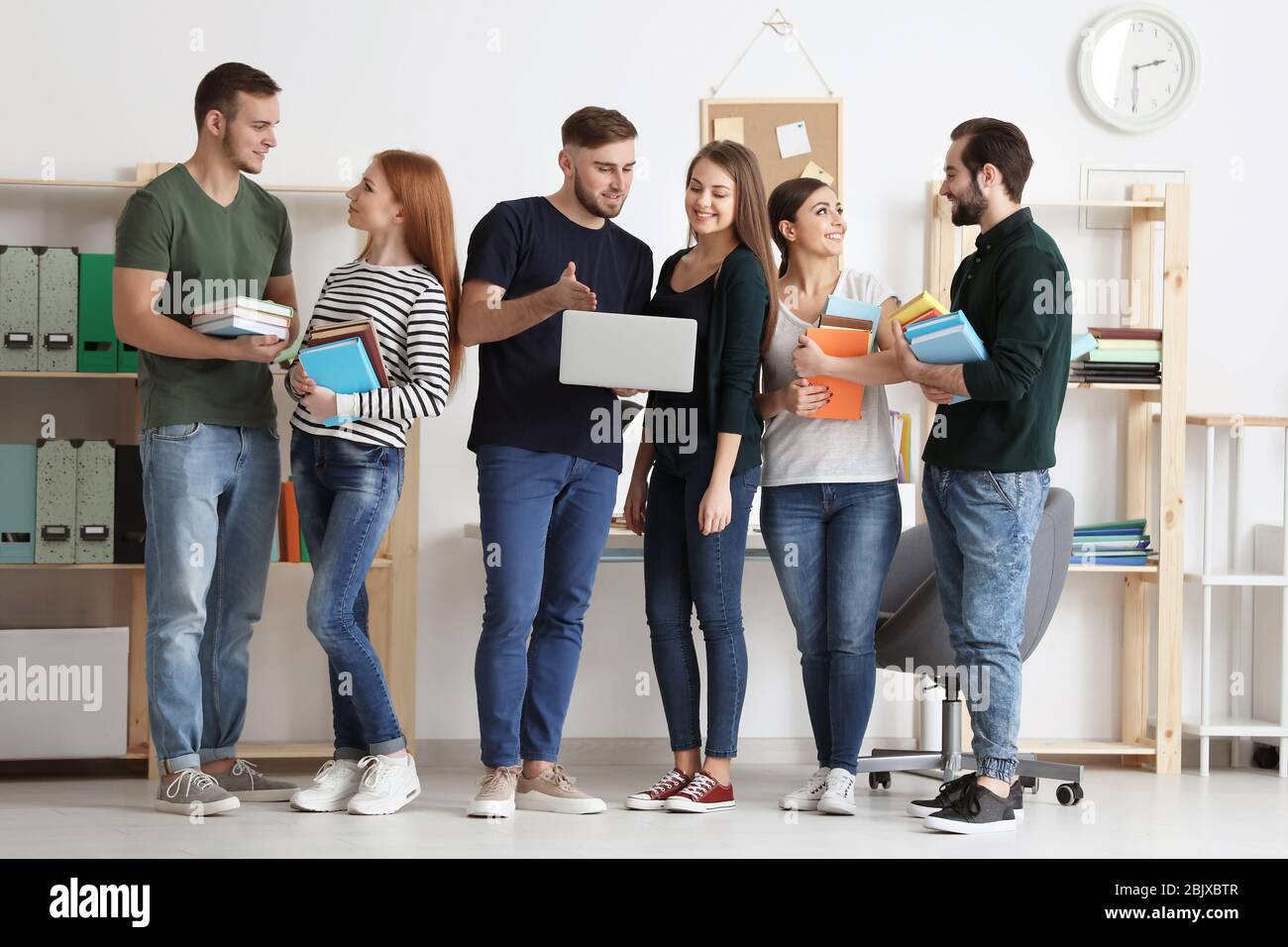 Students doing homework together in classroom Stock Photo - Alamy