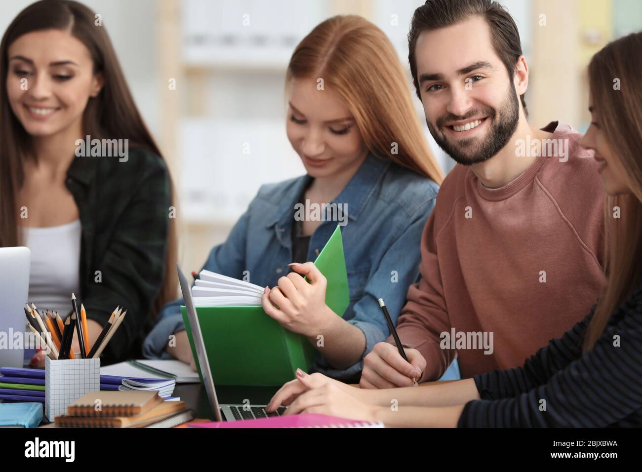 Students doing homework together in library Stock Photo - Alamy