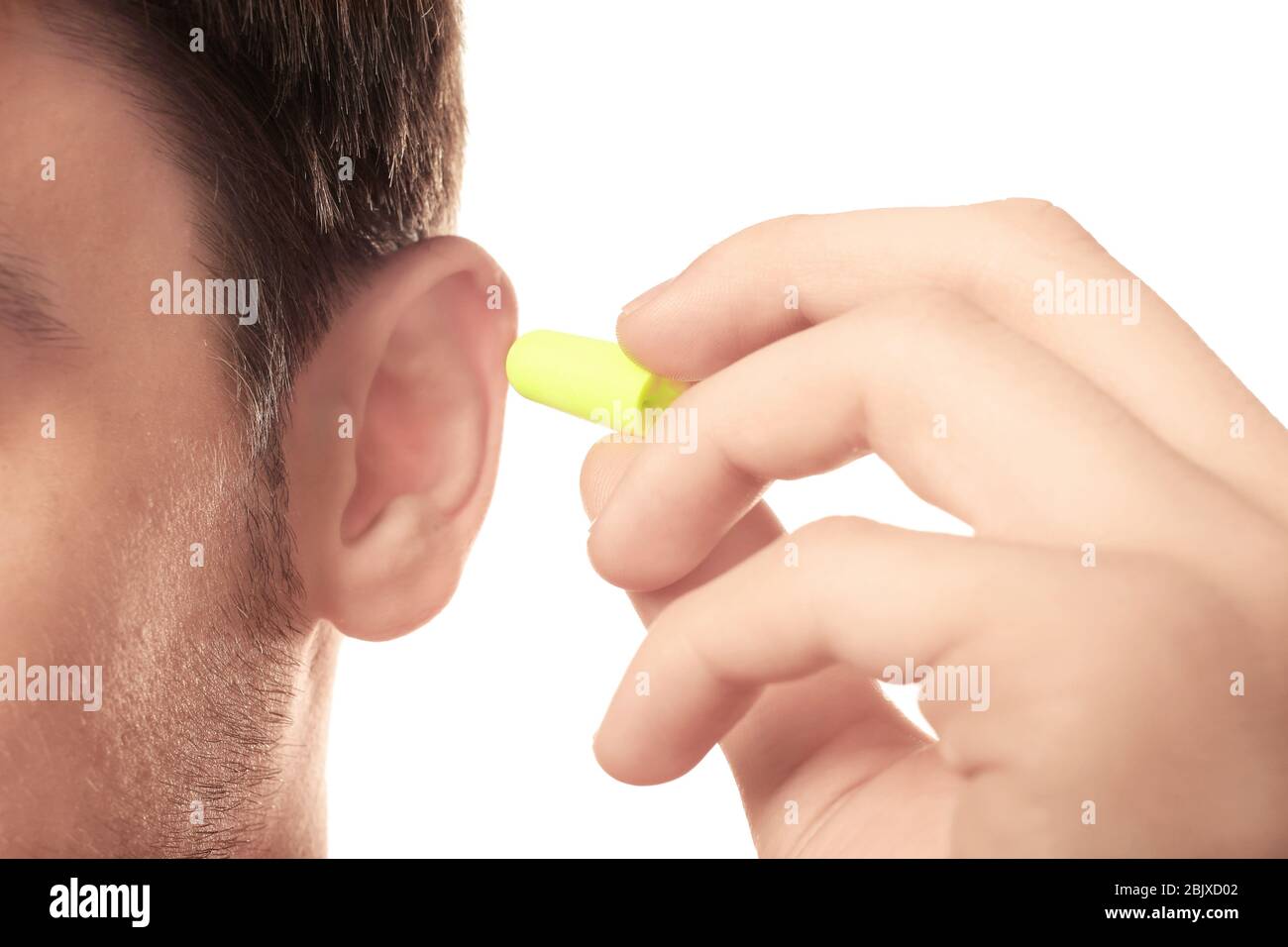 Man with earplug on white background, closeup. Hearing protection ...