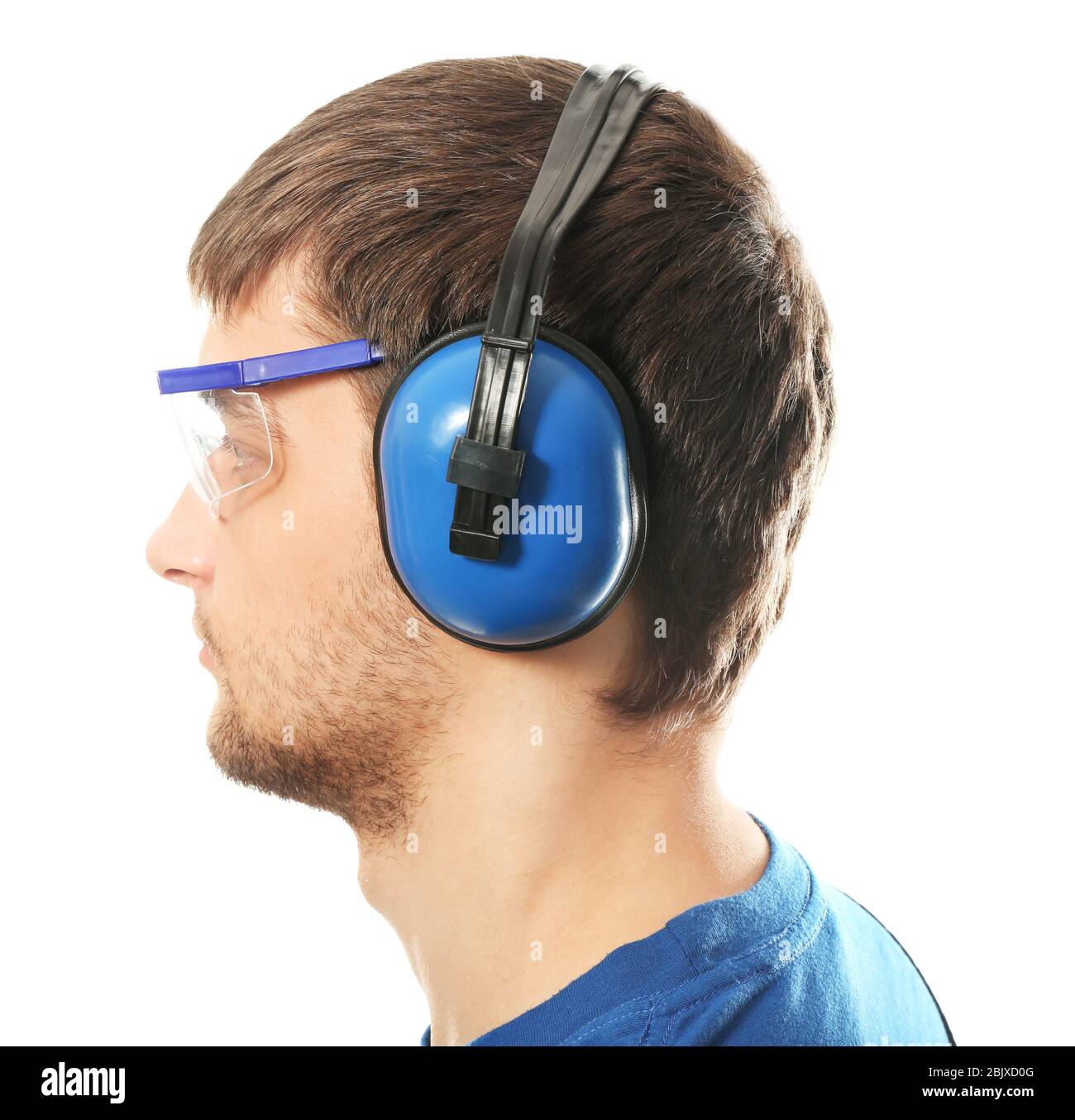 Male worker with headphones on white background. Hearing protection ...
