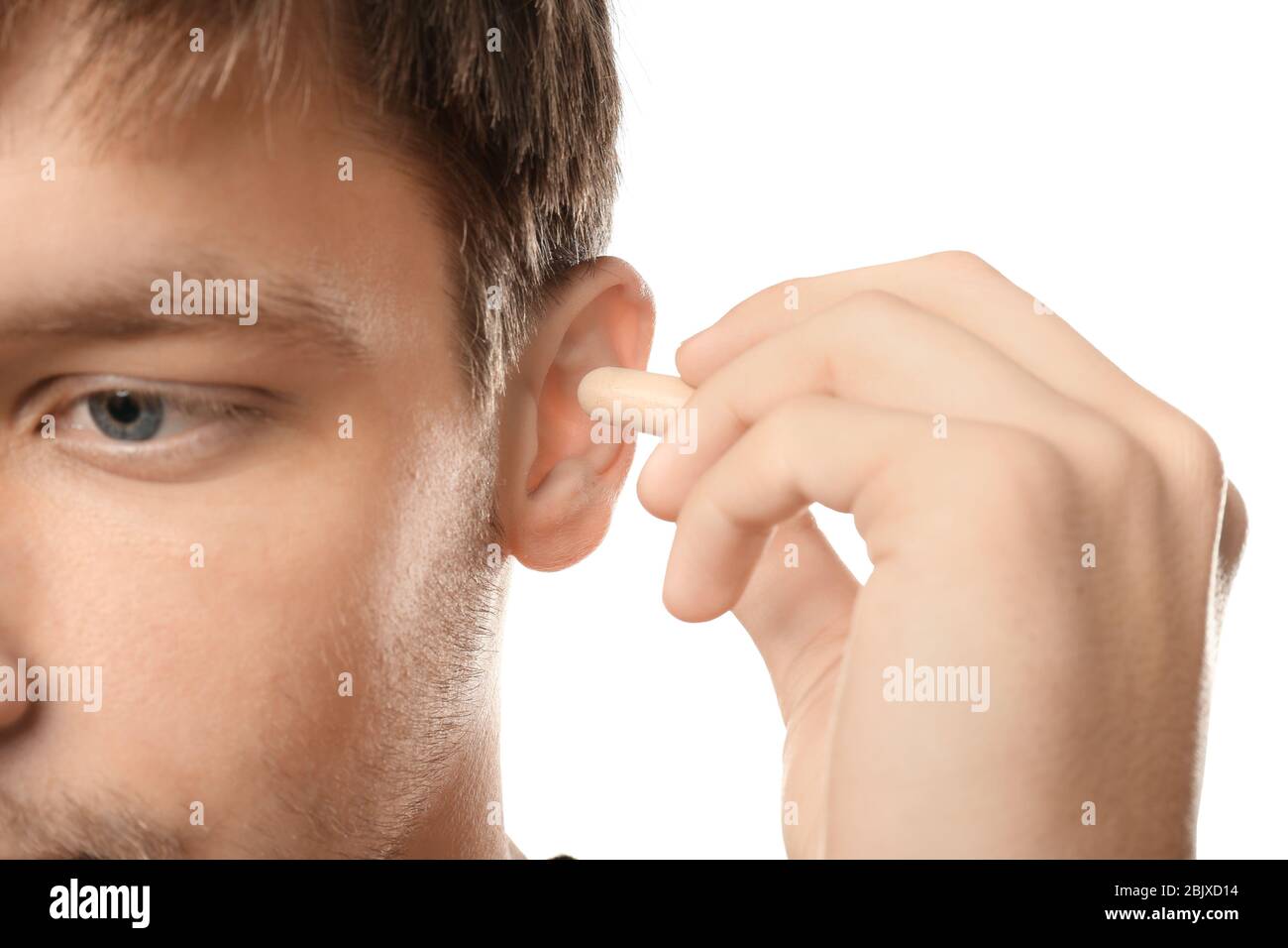 Man with earplug on white background, closeup. Hearing protection ...