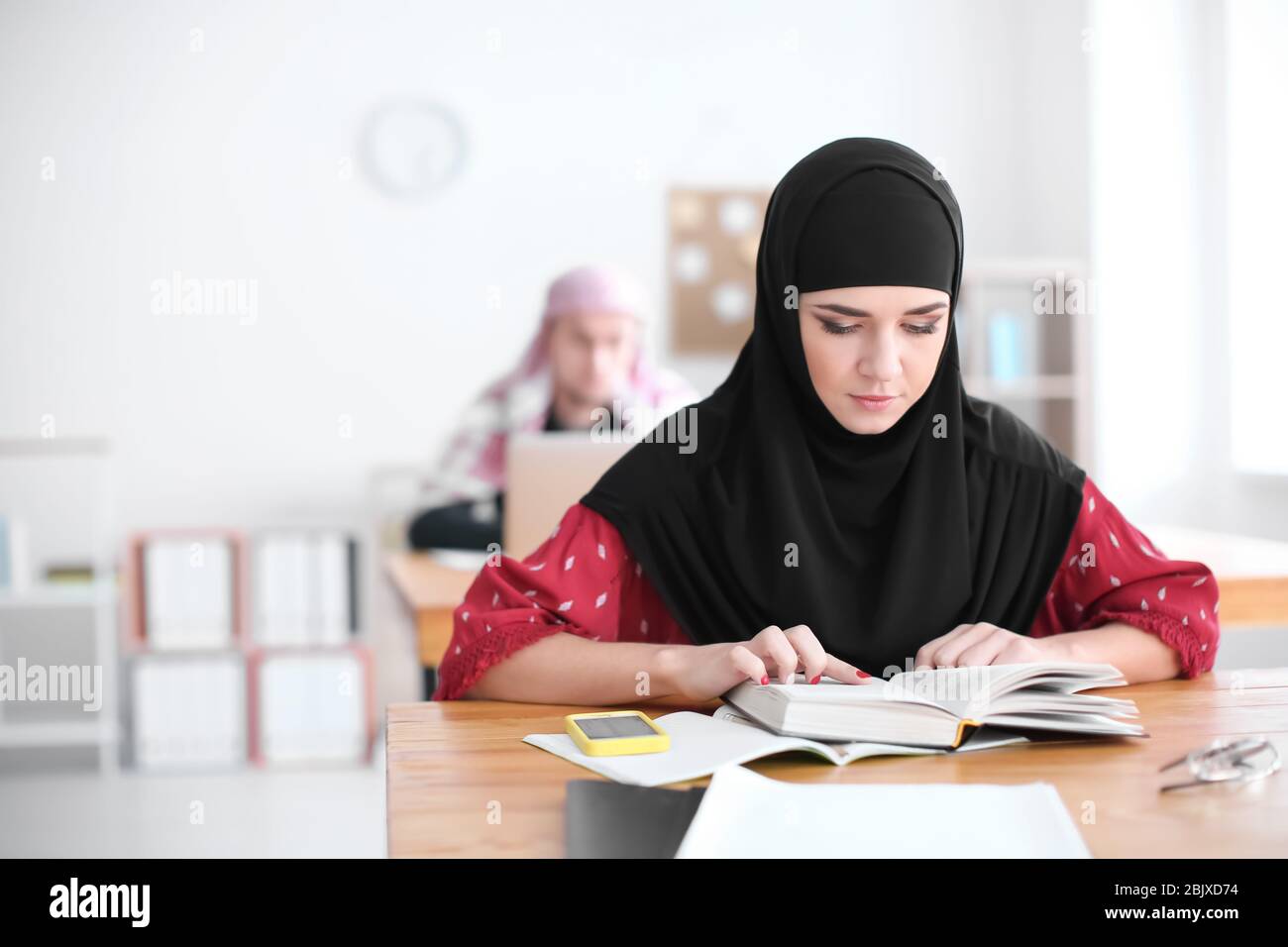 Muslim student wearing traditional clothes in classroom Stock Photo - Alamy