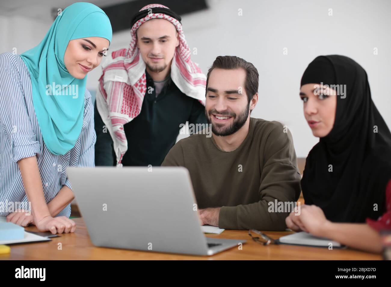 Male student and his Muslim classmates in library Stock Photo - Alamy