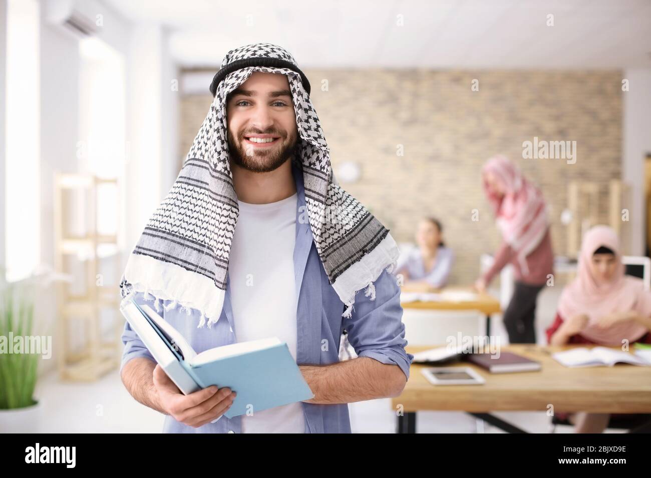 Muslim student wearing traditional clothes in classroom Stock Photo - Alamy