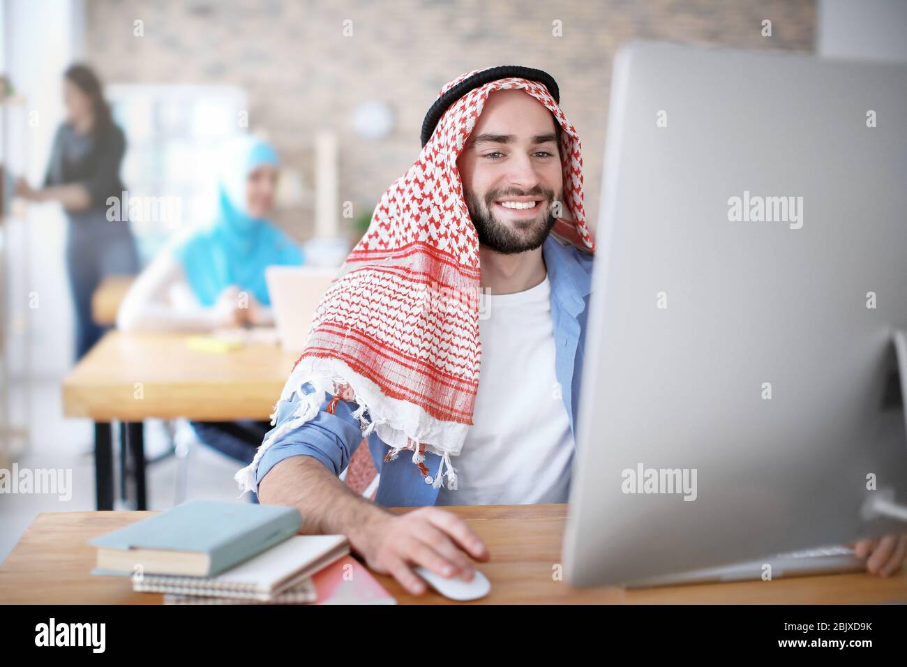 Muslim man in traditional clothes studying indoors Stock Photo - Alamy