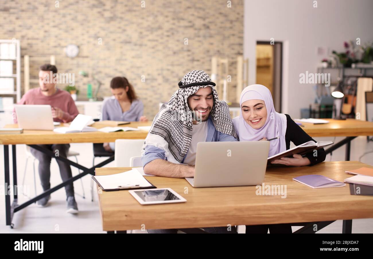 Muslim students in traditional clothes studying indoors Stock Photo - Alamy