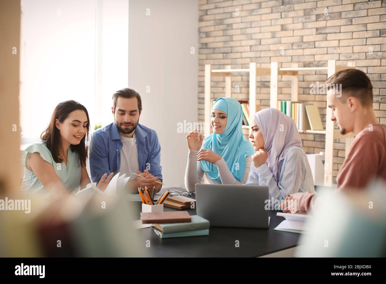 Muslim students with their classmates in library Stock Photo - Alamy