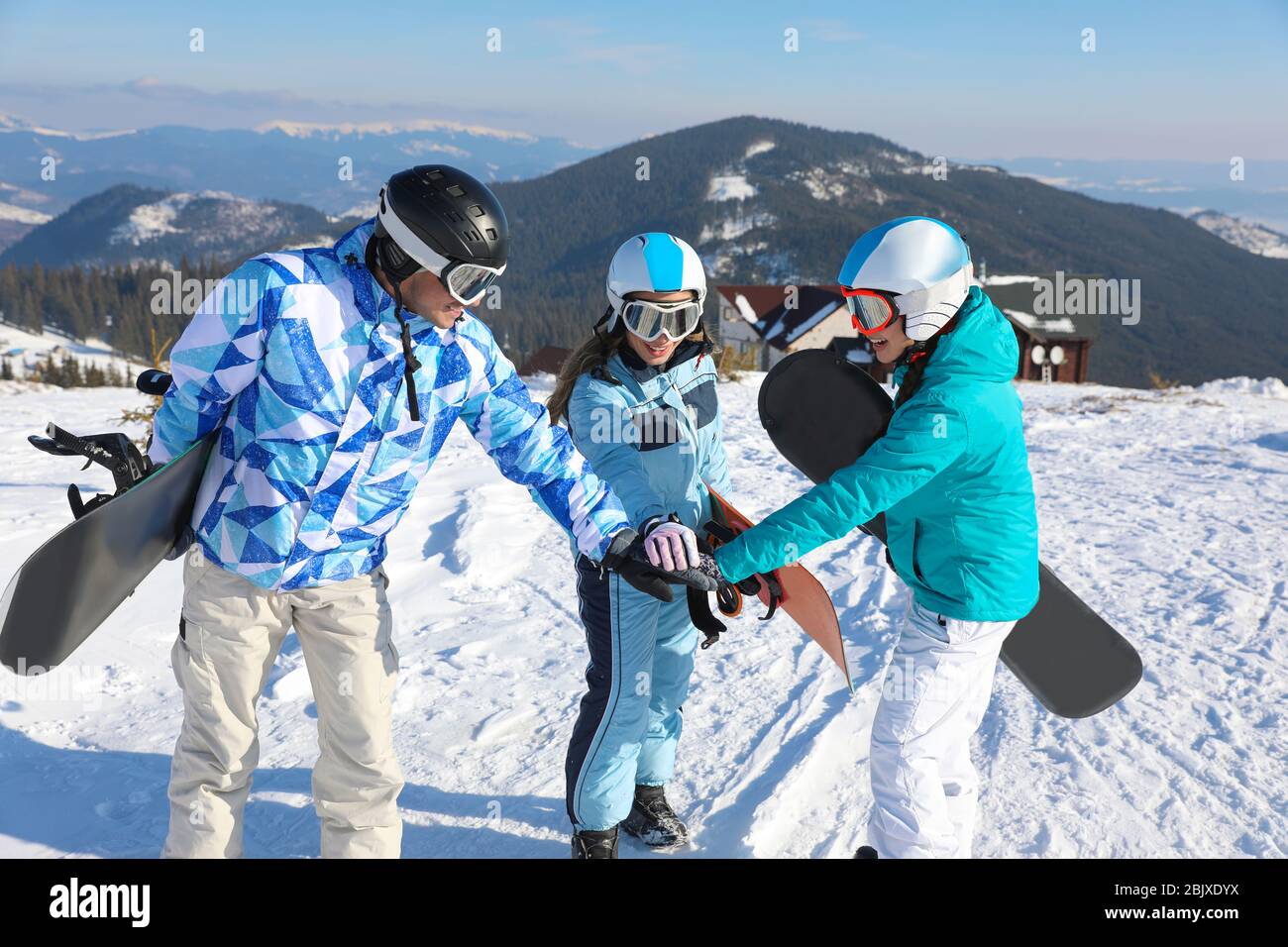 Group of snowboarders on ski piste at snowy resort. Winter vacation ...