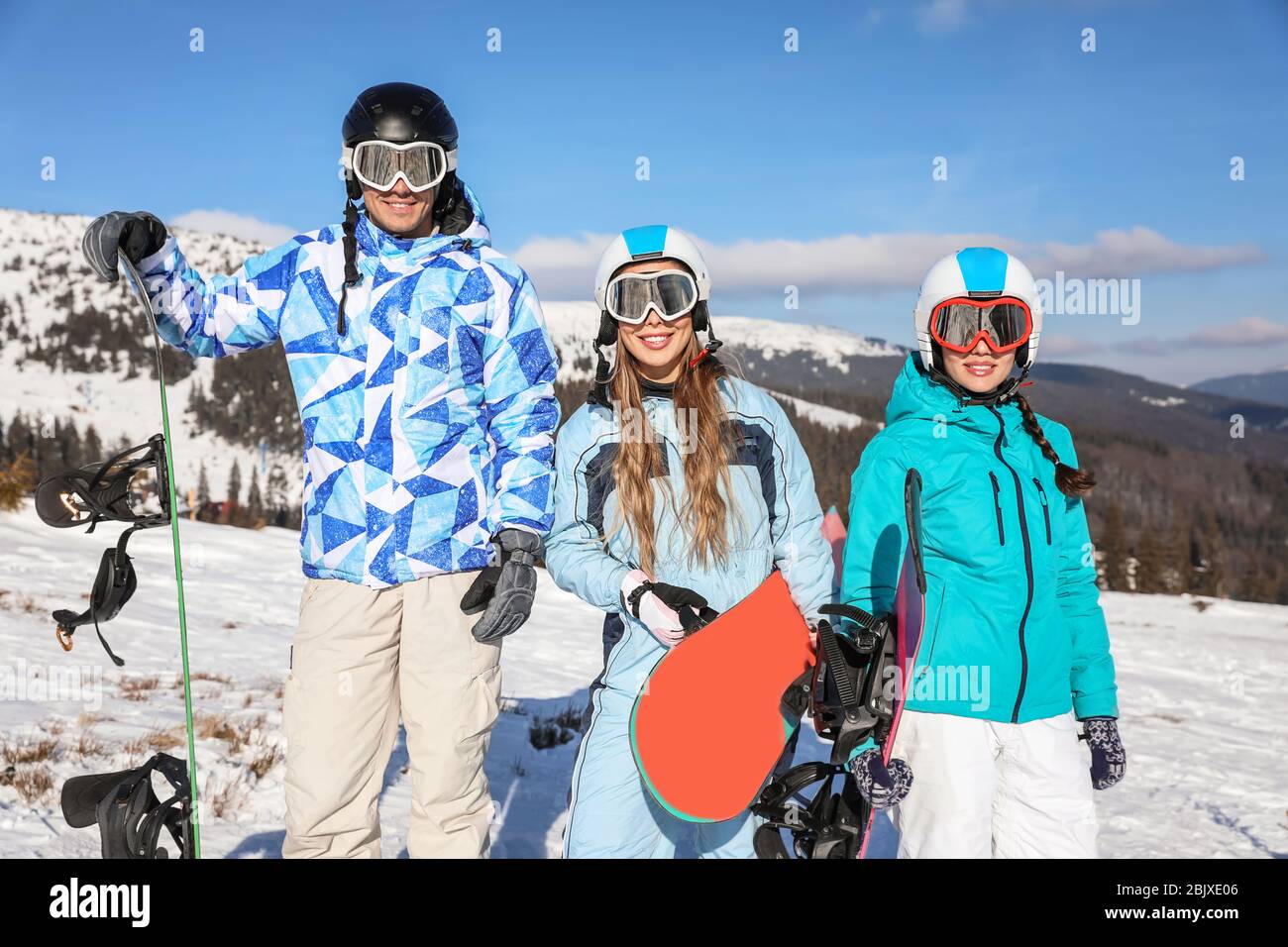 Group of snowboarders on ski piste at snowy resort. Winter vacation ...