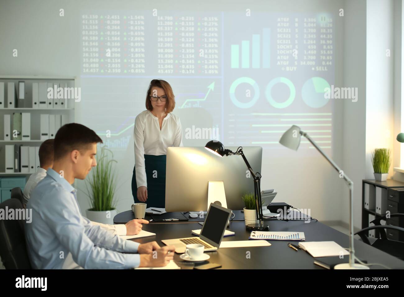 Office employees watching presentation during meeting. Forex concept ...