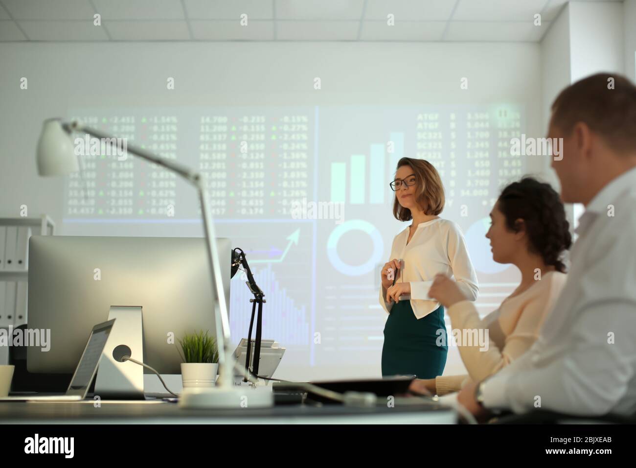Office employees watching presentation during meeting. Forex concept ...