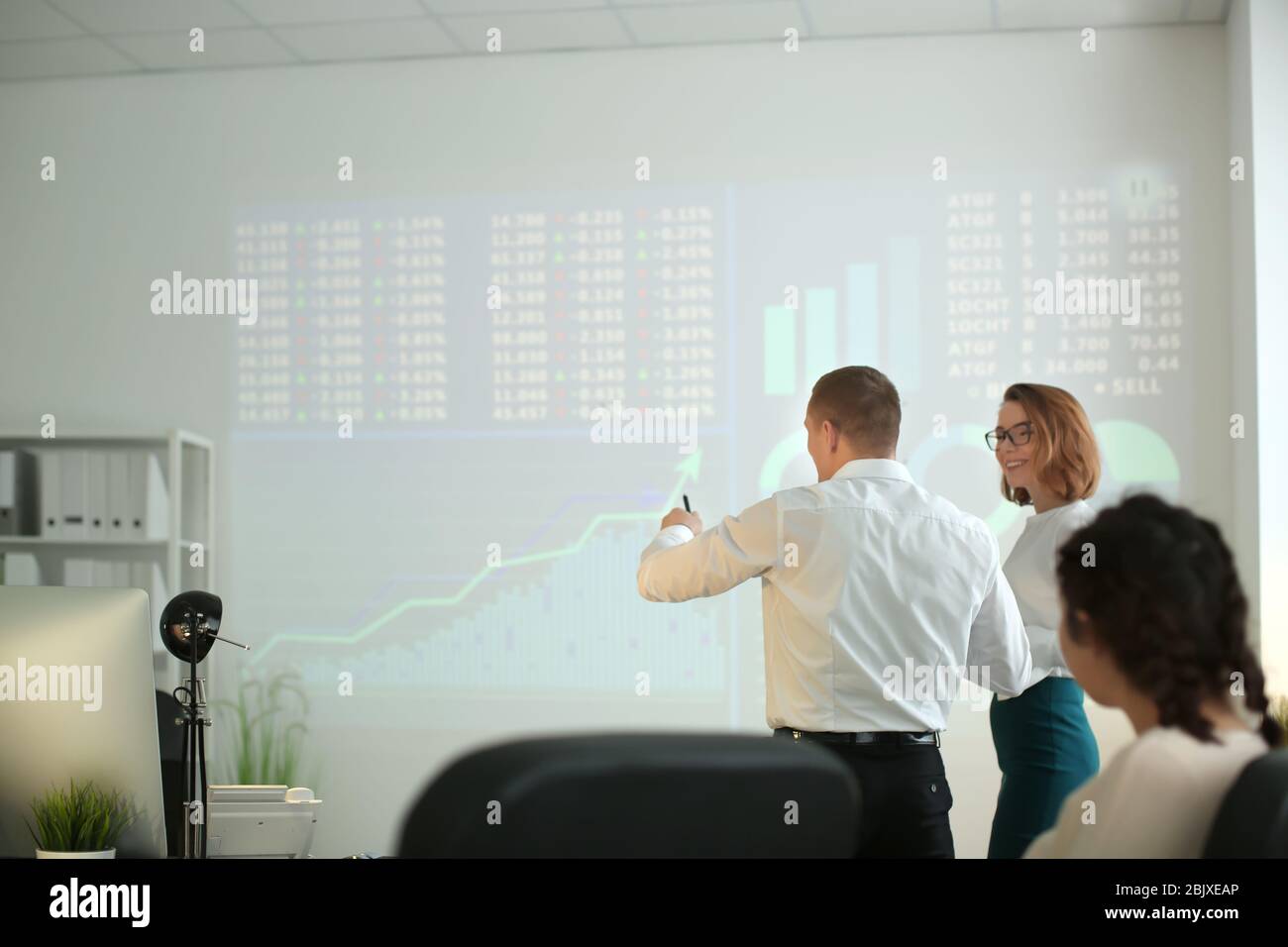 Office employees watching presentation during meeting. Forex concept ...