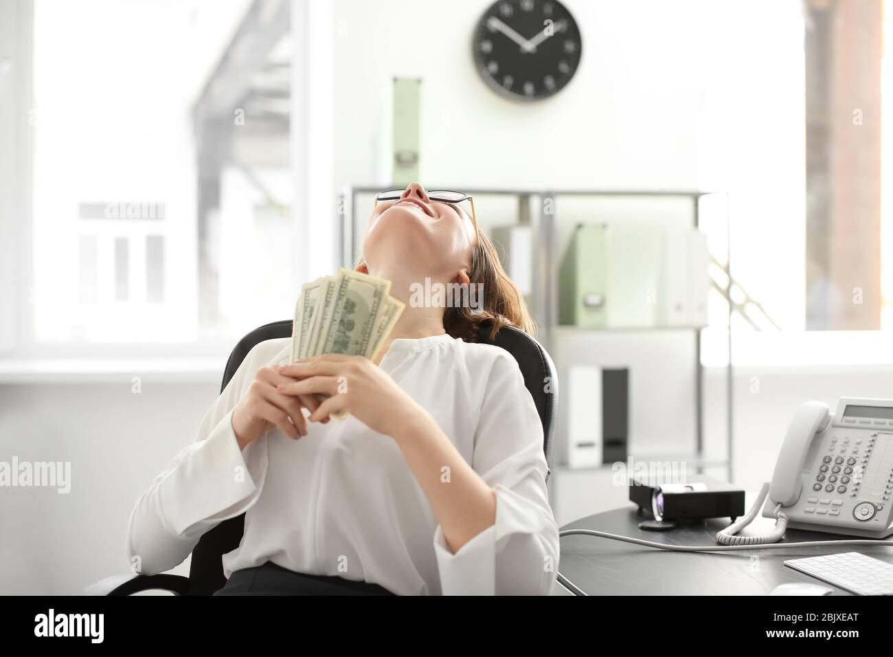 Office employee with money at workplace. Forex concept Stock Photo - Alamy