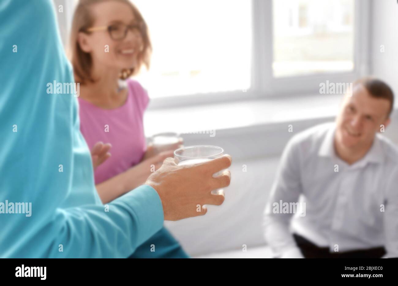 Office employees drinking water during break Stock Photo - Alamy