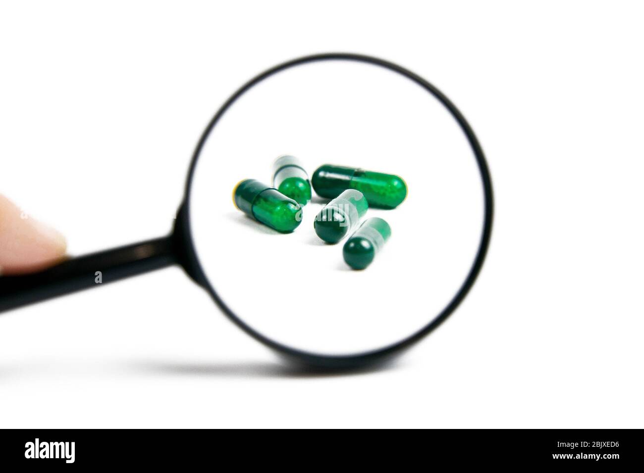 Zooming pills using magnifier glass. Special unique pills isolated on ...