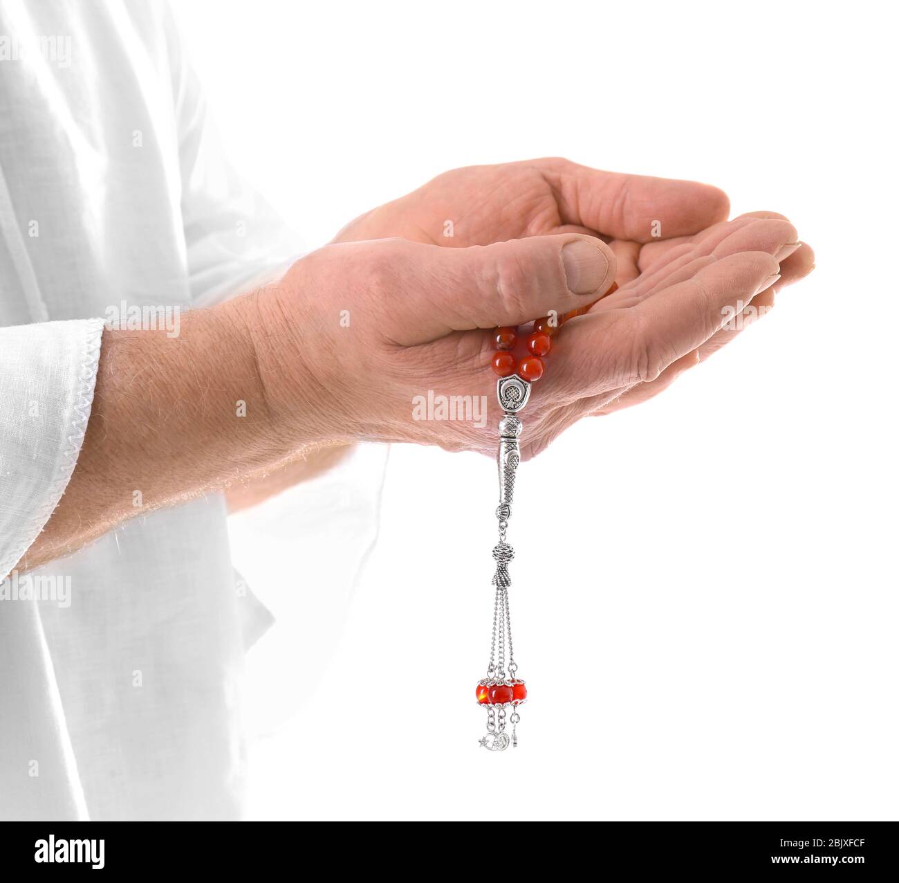 Senior Muslim man holding beads on white background Stock Photo - Alamy