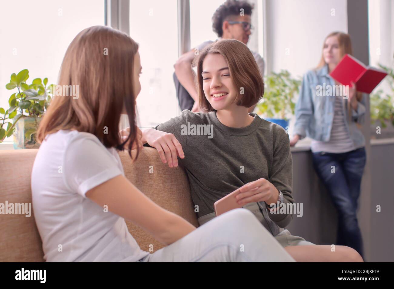 Students resting together in campus building Stock Photo - Alamy