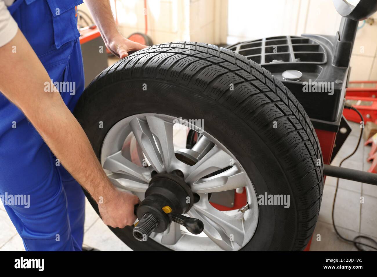 Mechanic balancing wheel in hi-res stock photography and images - Alamy