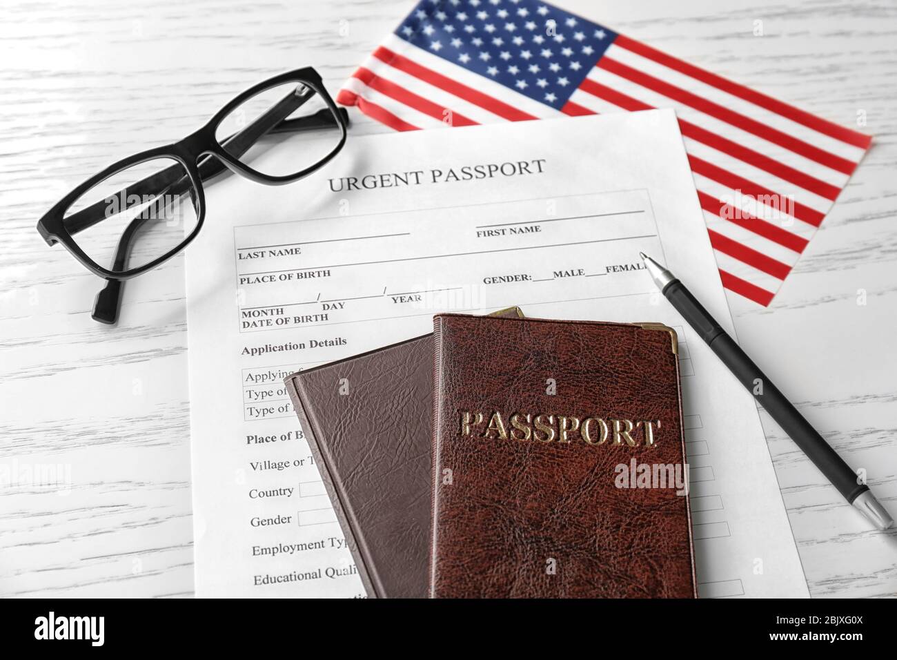 Passports, application form and American flag on table. Immigration to ...