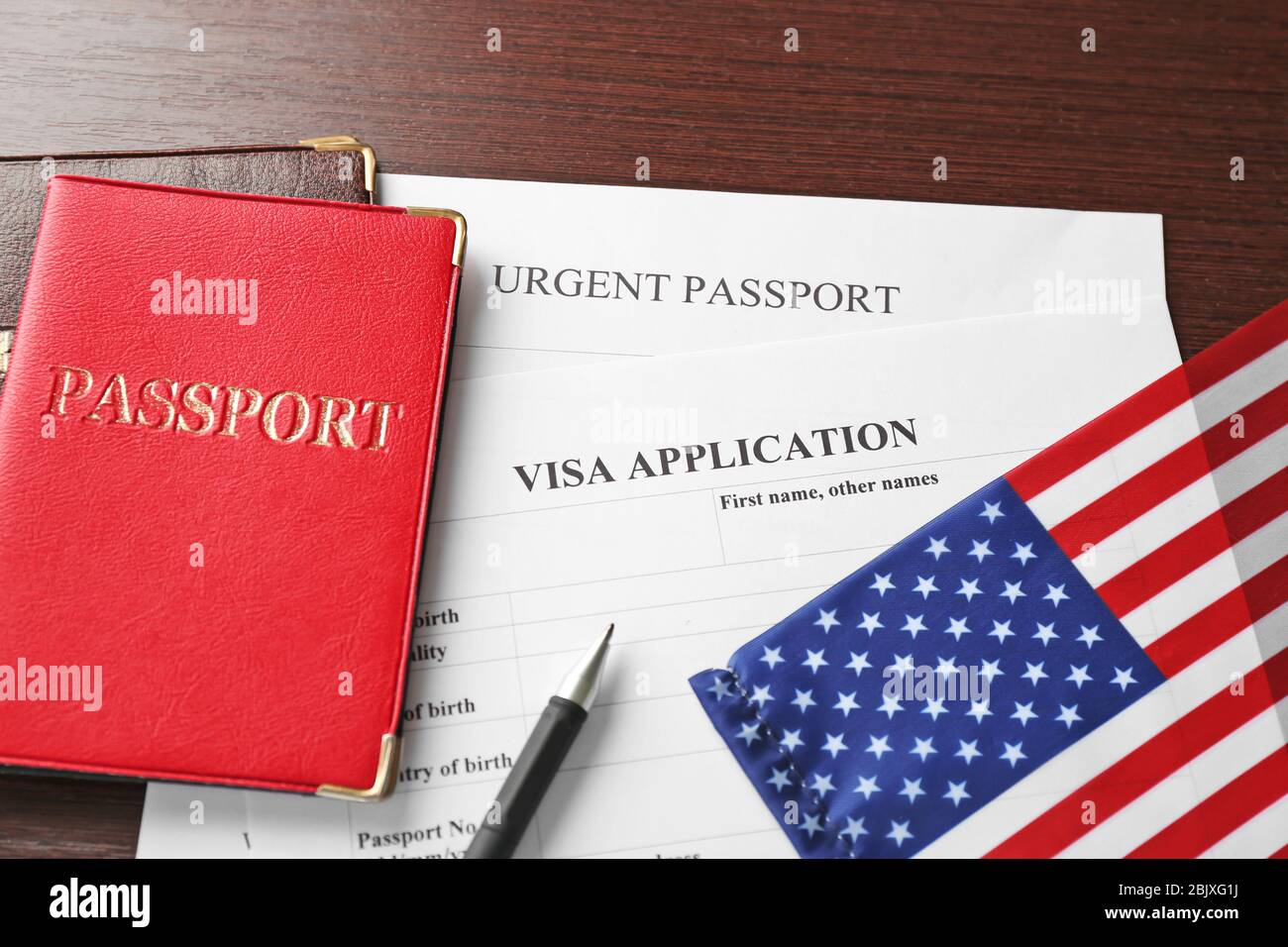 Passports, American flag and visa application form on table ...