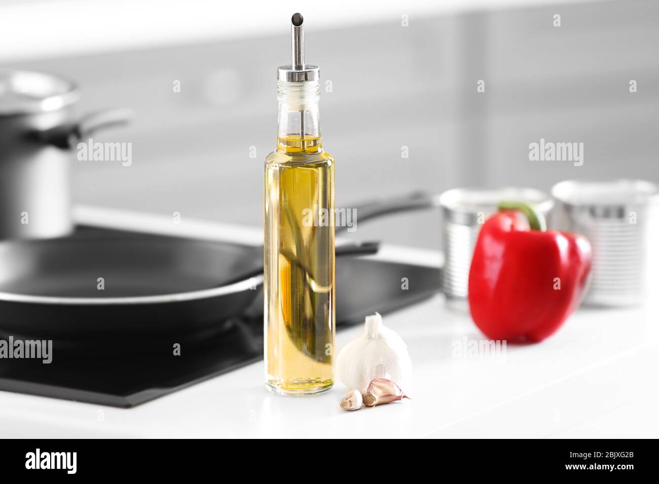 Glass bottle of cooking oil on kitchen counter Stock Photo - Alamy