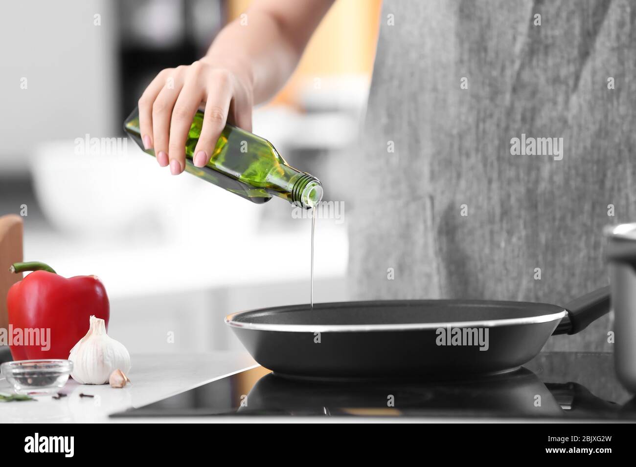 Woman pouring cooking oil hi-res stock photography and images - Alamy