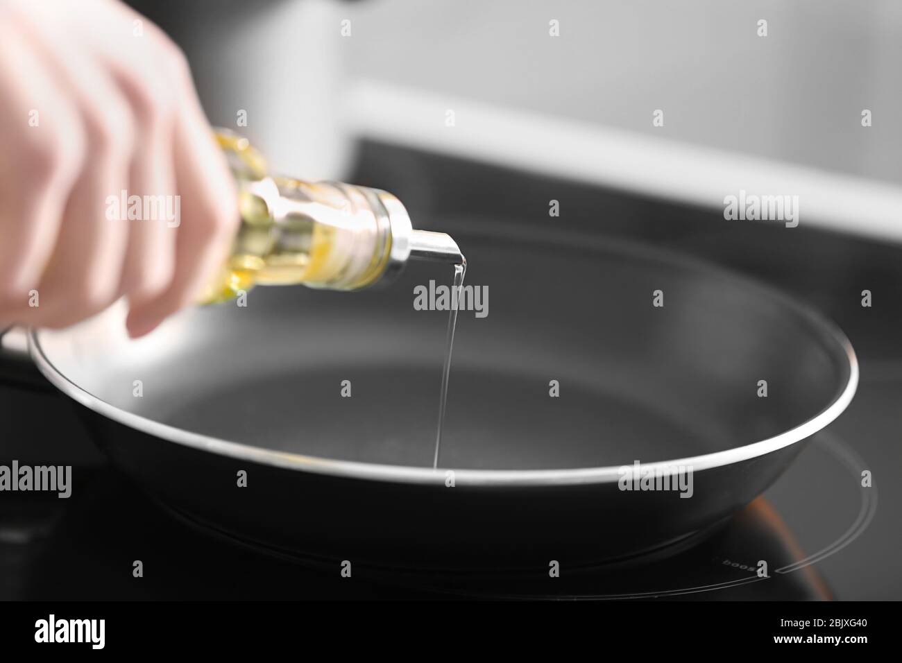 Woman pouring cooking oil hi-res stock photography and images - Alamy