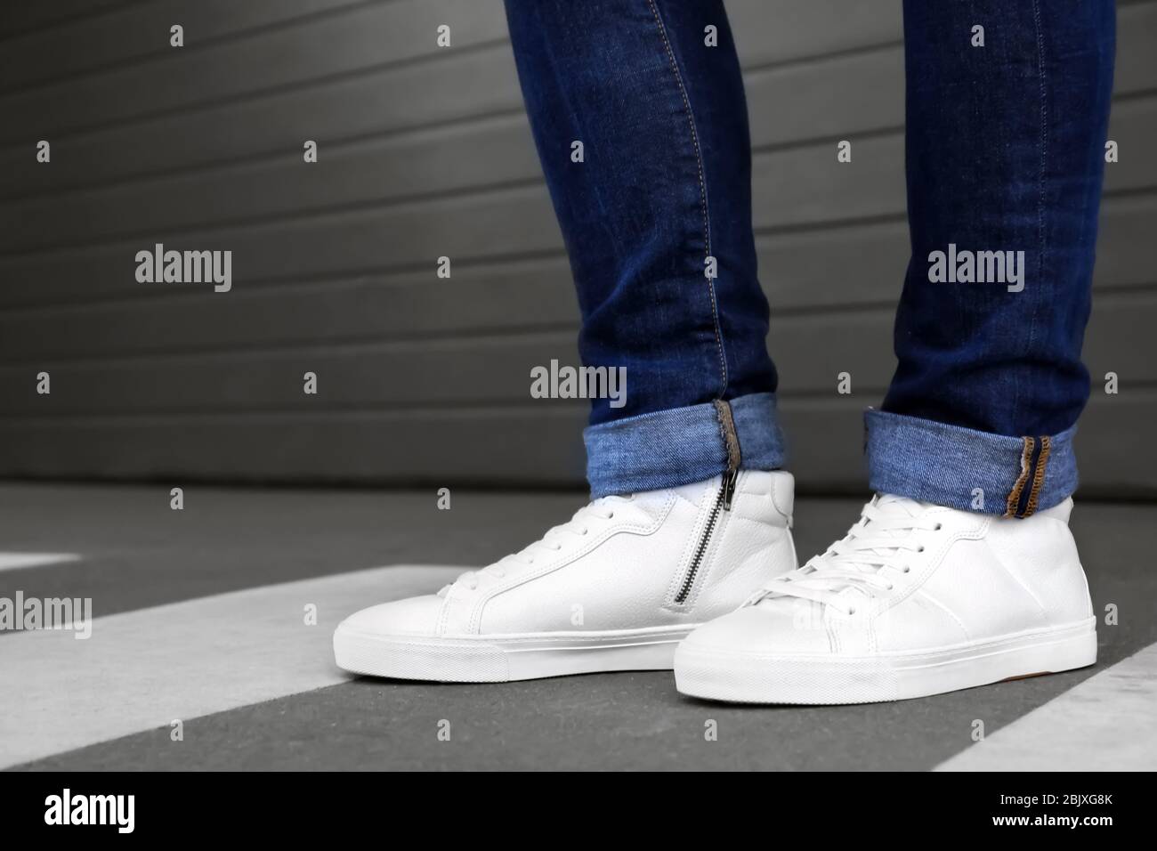 Stylish man in white shoes on city street Stock Photo - Alamy